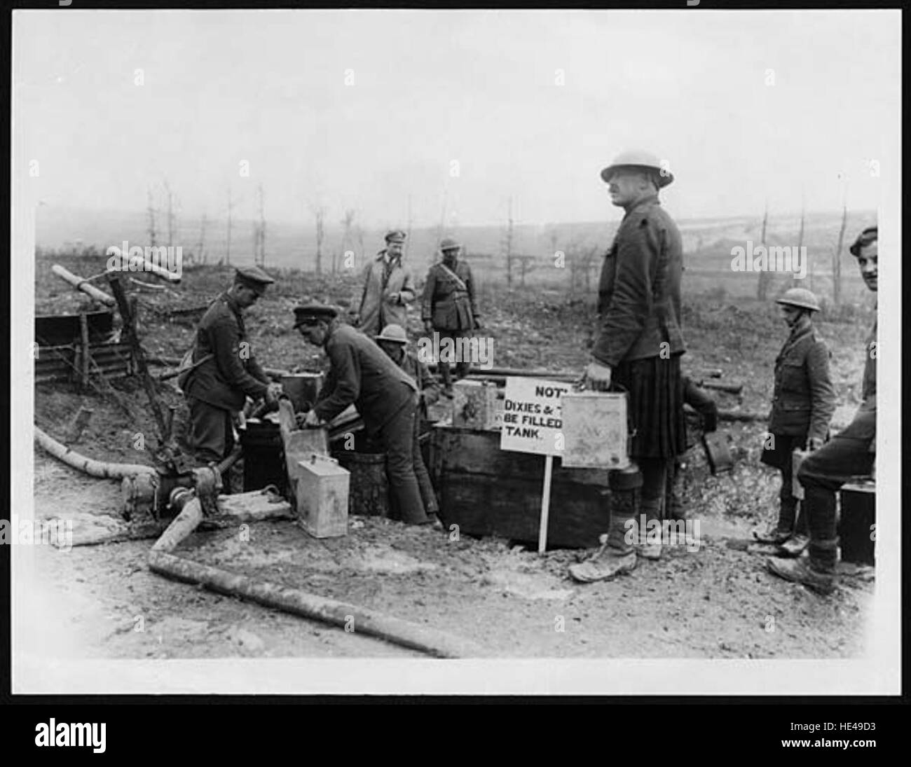 This historical photograph depicts a military water supply operation ...