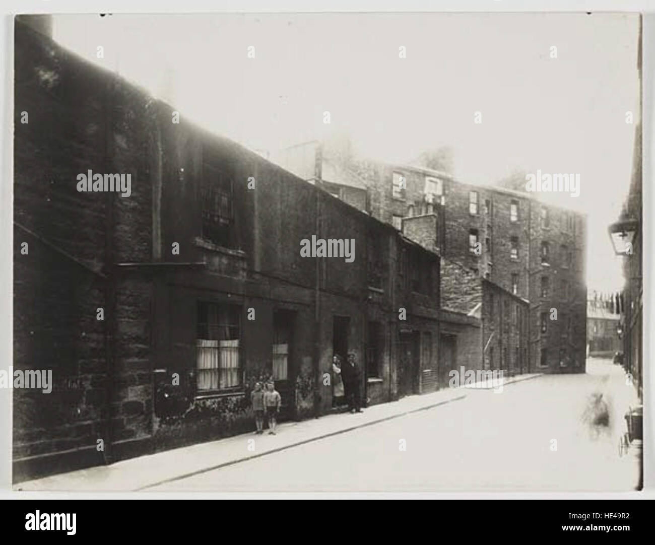 This historical image depicts a one-storey building leading up to a ...