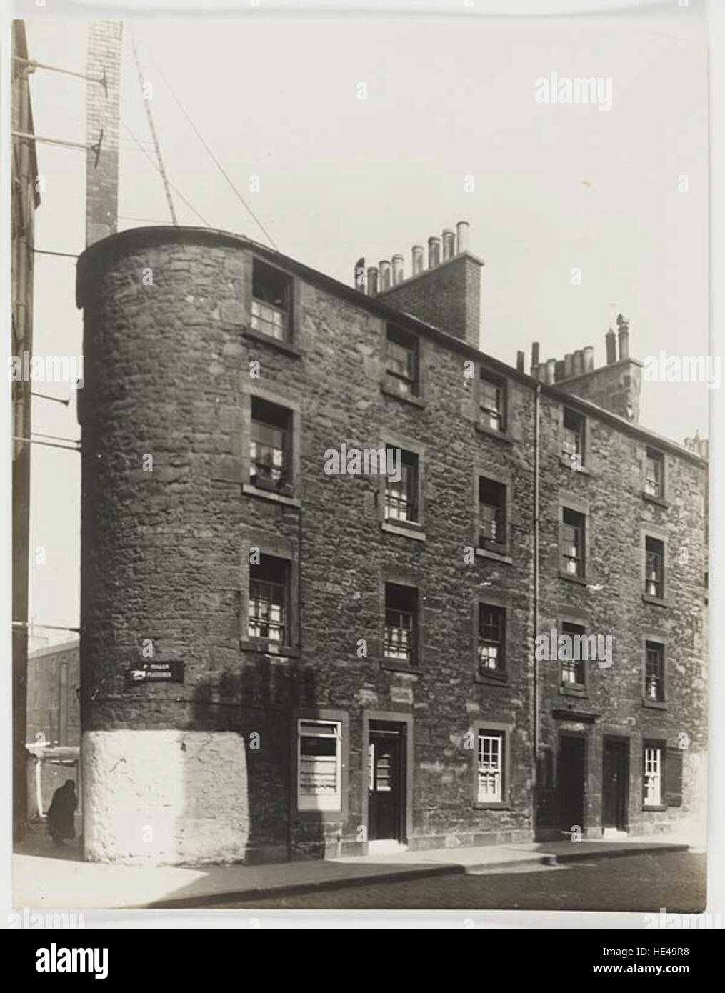 A historical three-storey building with a curved side, this ...