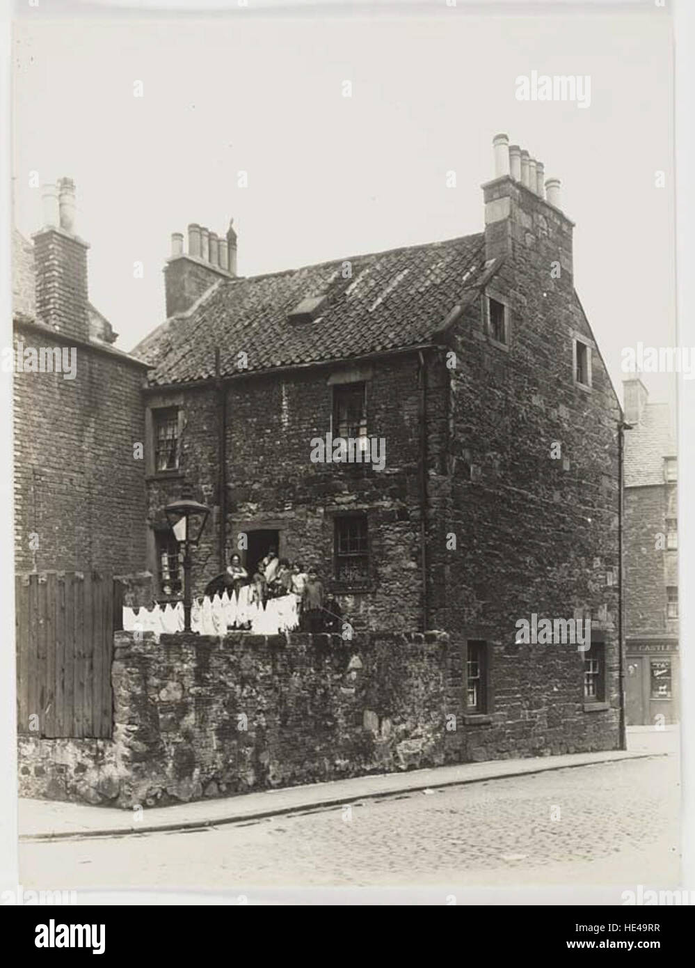 This image captures a walled backyard of a two-story house, likely from ...