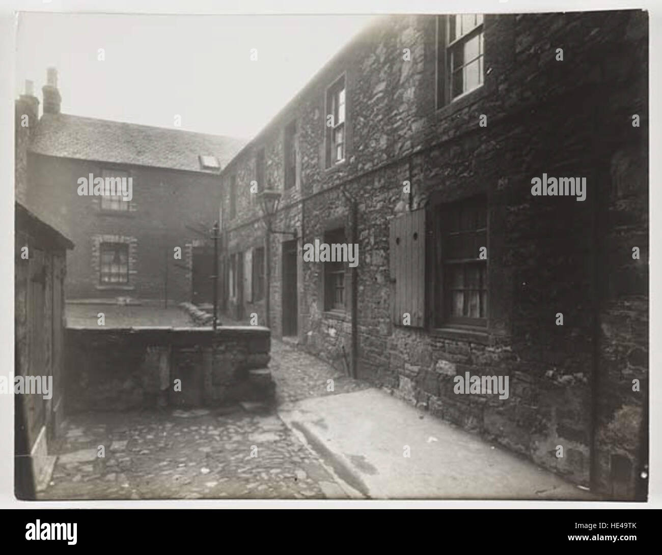 This historical image shows a backview of a one-story building ...