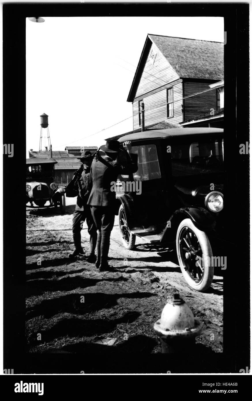 This historical image shows the State Militia in charge of the ...