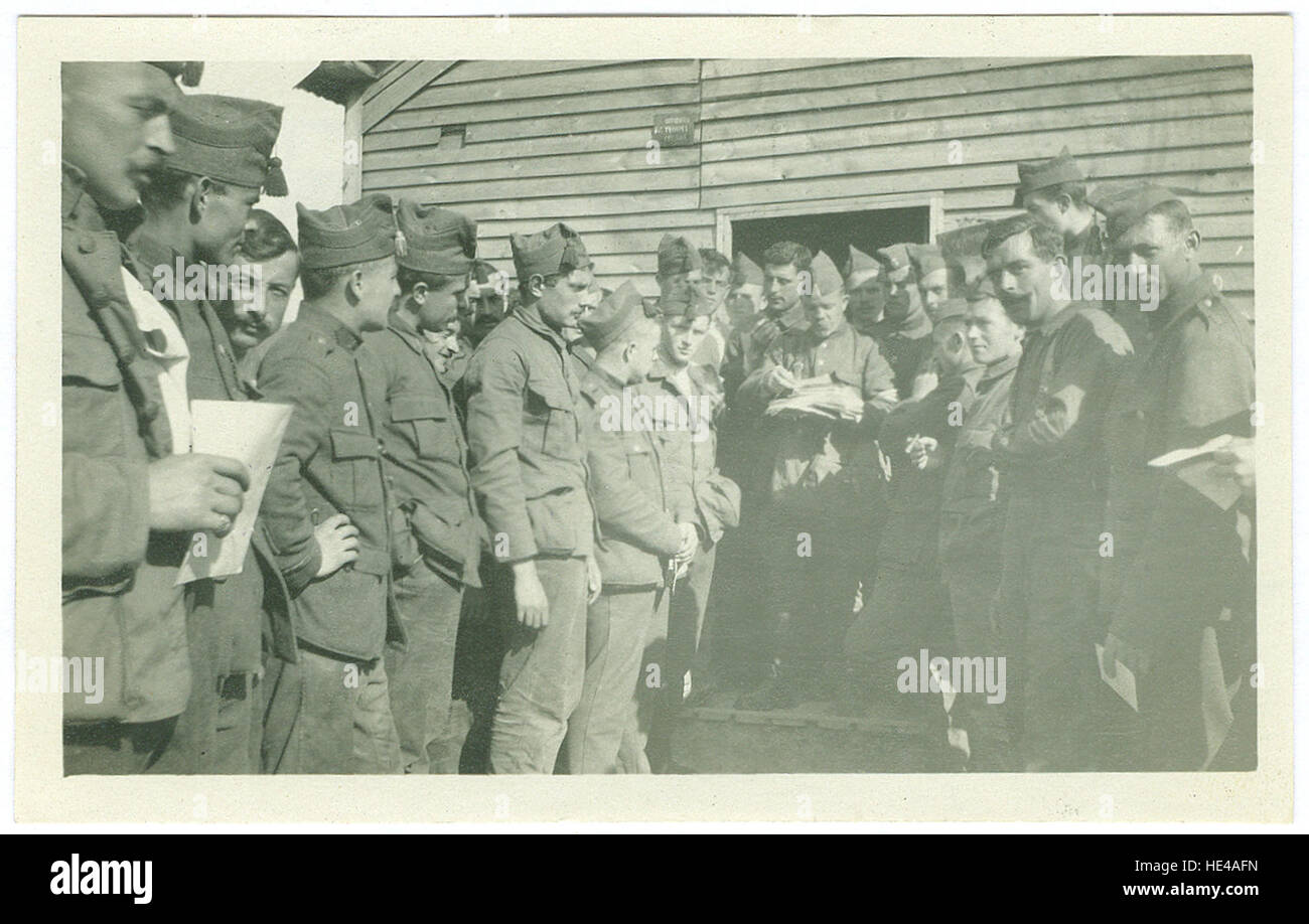 This historical image captures the process of mail call, where military ...