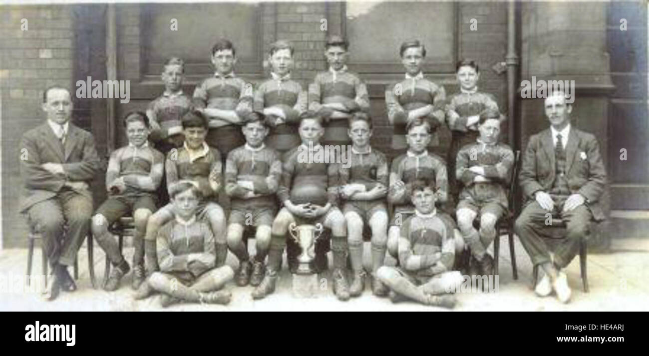 This historical photograph shows a school rugby team from the past. It ...