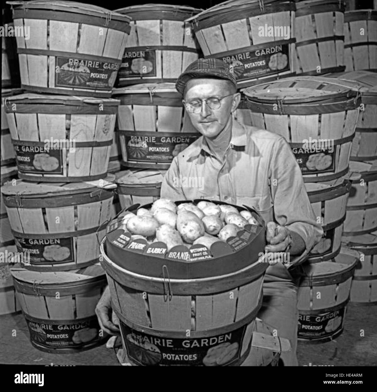 This historic photograph captures George W. Leonard, holding a basket ...