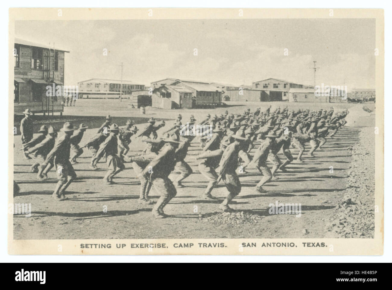 This historic photograph depicts soldiers setting up for a military ...