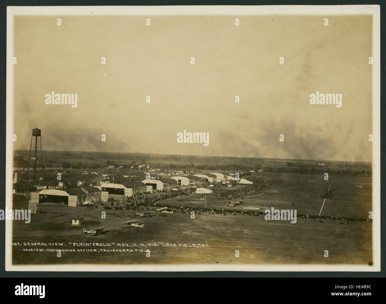 This historical photograph features a Curtiss JN-4 biplane at Dallas ...