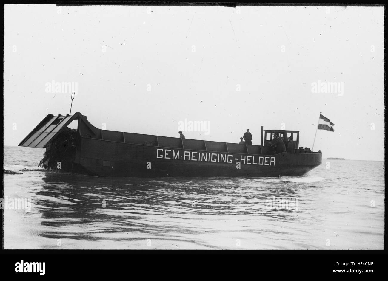 A historical photograph of a garbage boat, taken in Den Helder ...