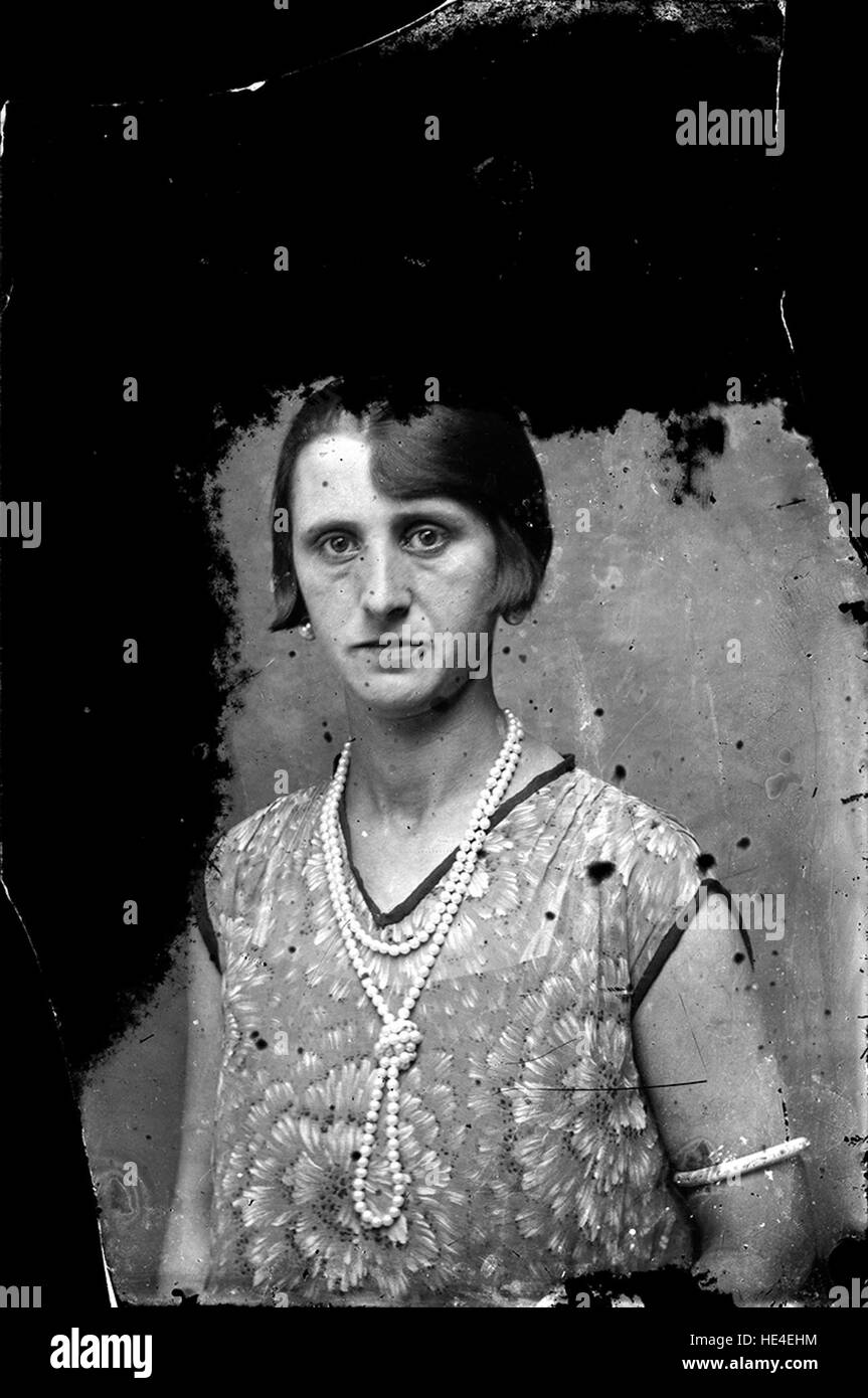 A woman adorned with pearls, captured in a historical portrait by ...