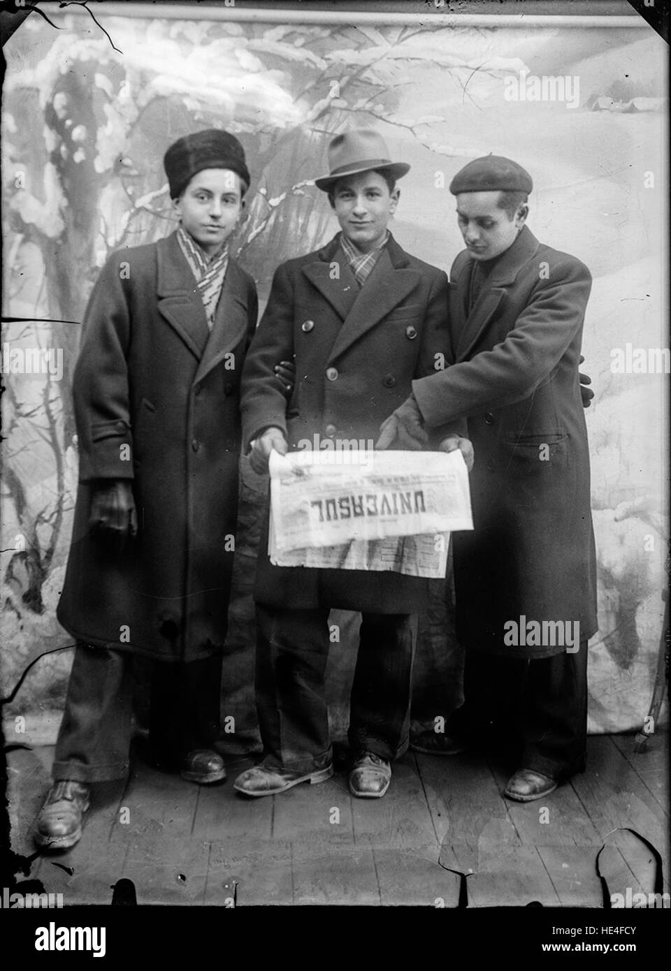 Three men reading the Universul newspaper in Ialomița, Romania ...