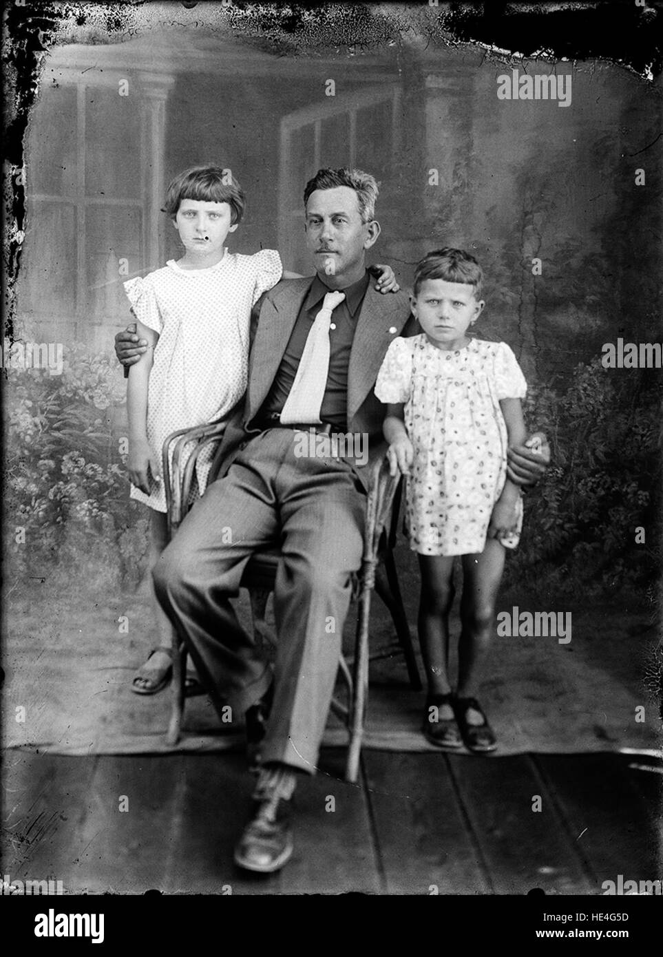 Father with children, captured in a historical photograph on glass ...