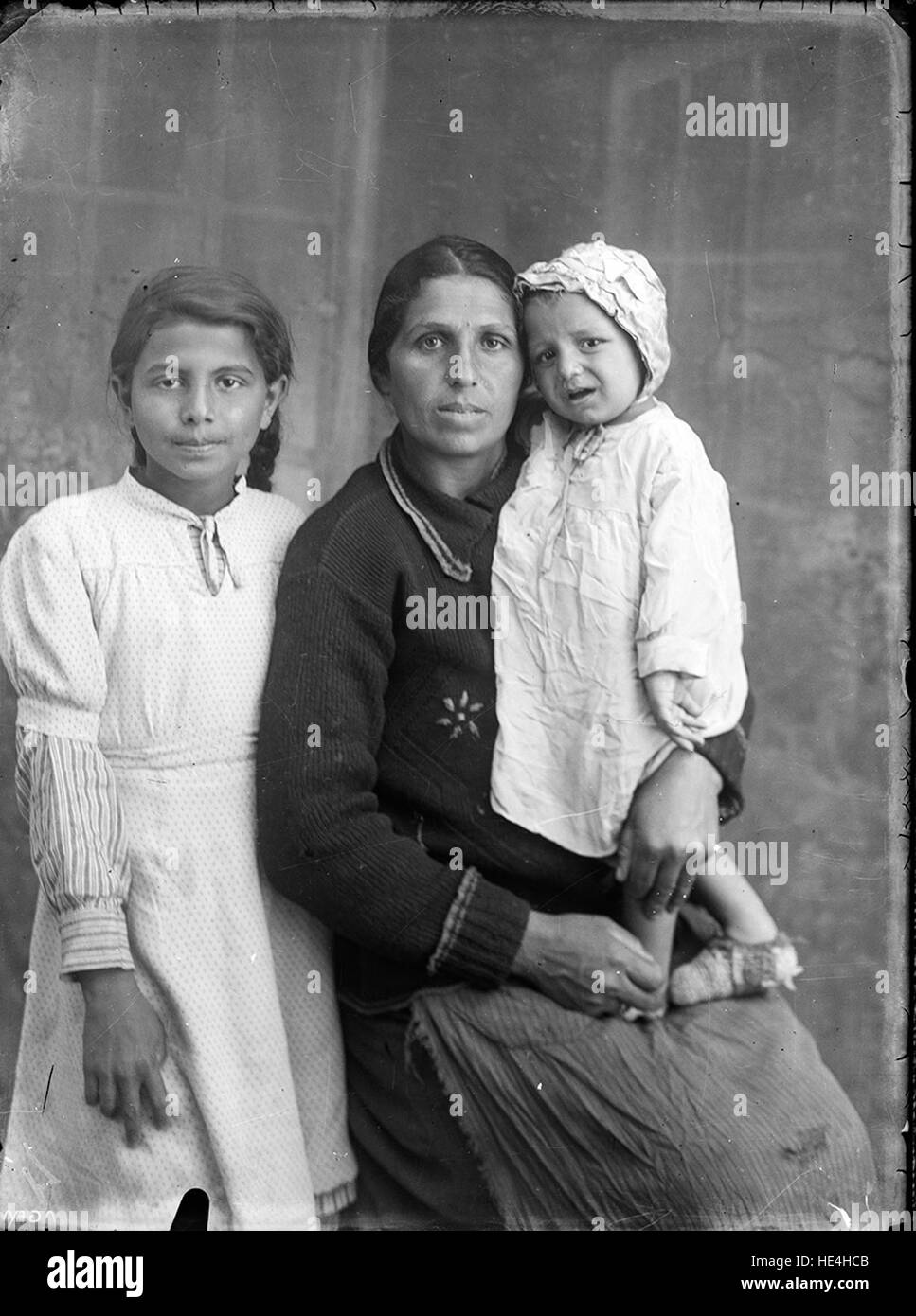 A photograph of a mother with her two children from rural Romania ...