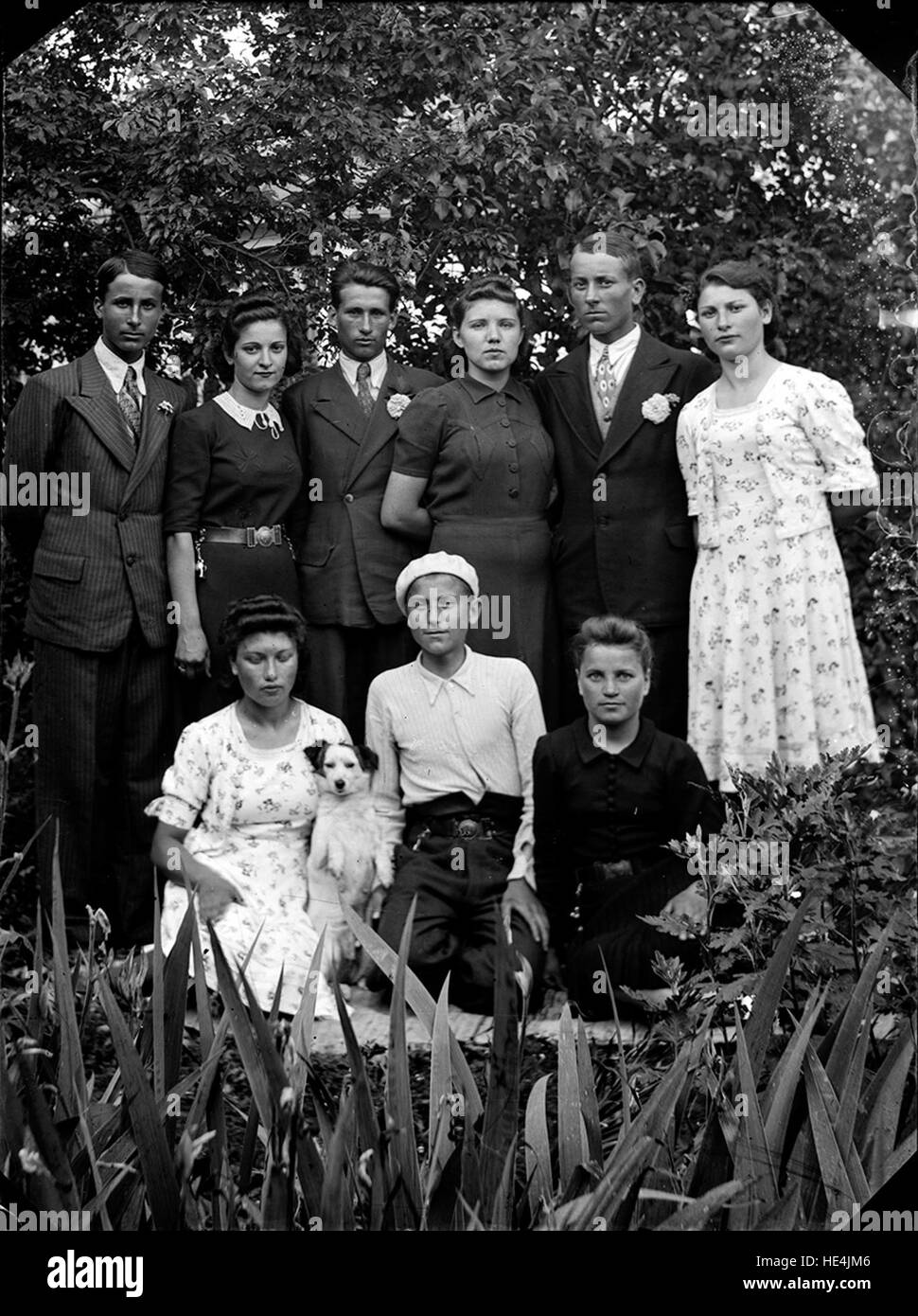 A group portrait of individuals from rural Romania, captured on a glass ...