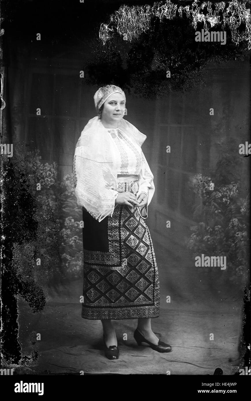 A woman dressed in traditional Romanian folk costume, captured in a ...