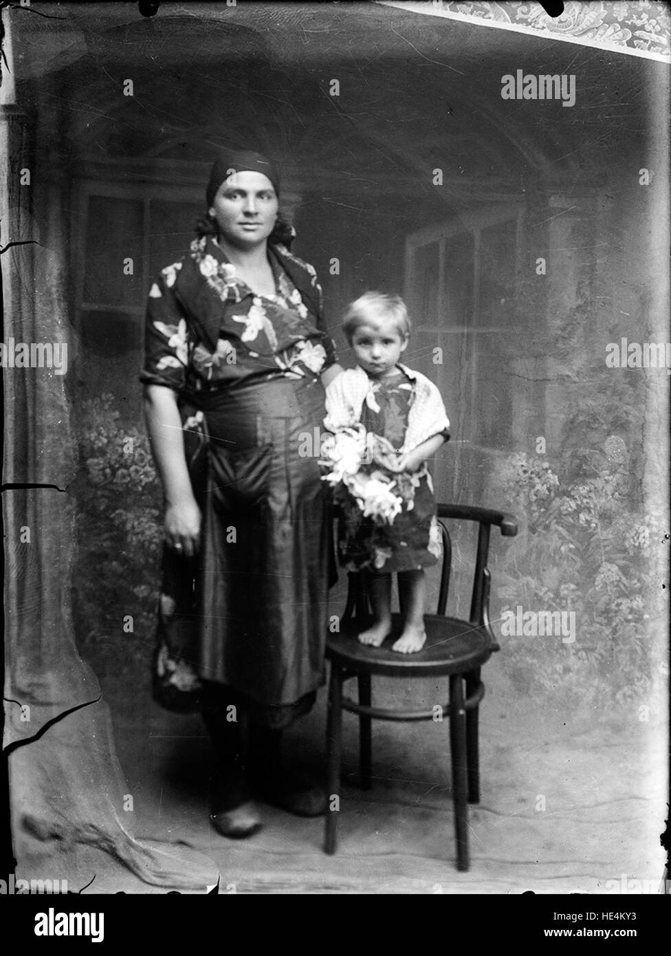 A Romanian mother with her child, captured in a poignant early 20th ...