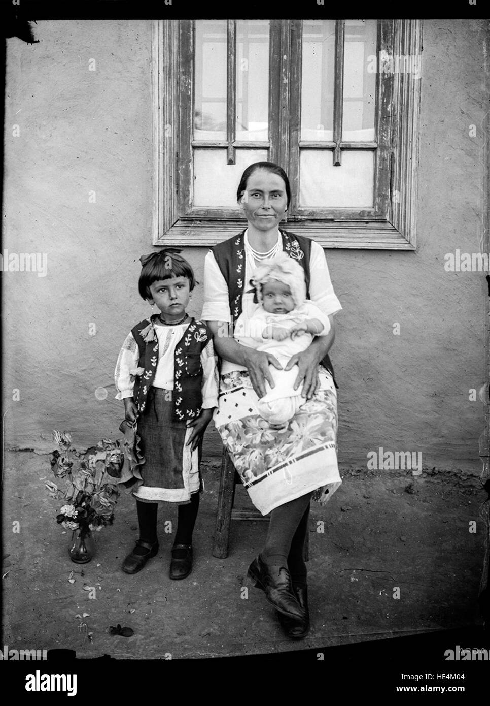 A mother with two children, captured in a historical photograph from ...