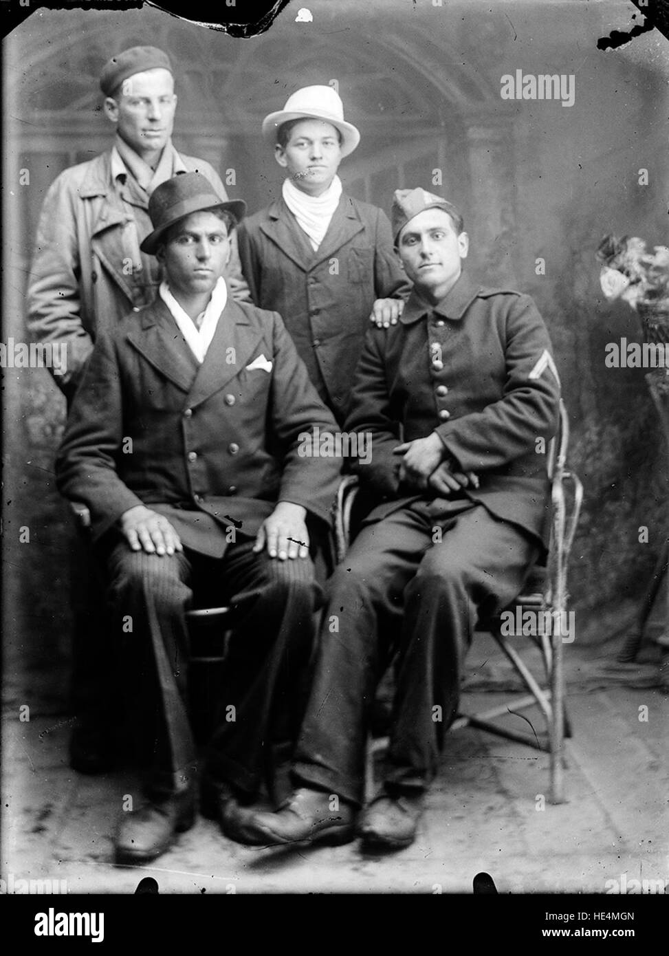 Four men in a historical photograph, with a soldier wearing a wound ...