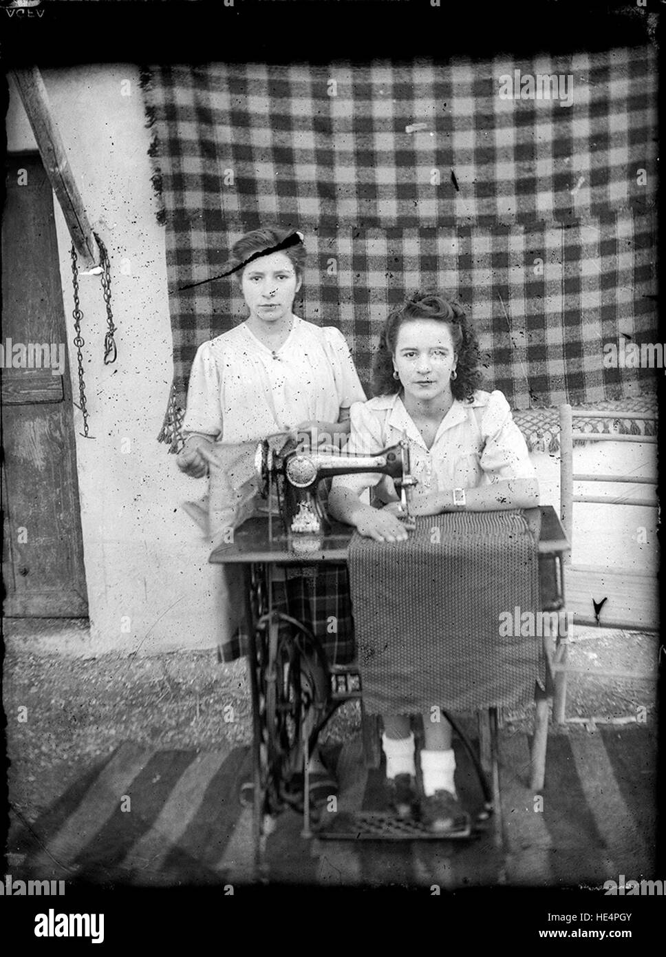 A photograph of two women from Ialomita, Romania, working with a Singer ...