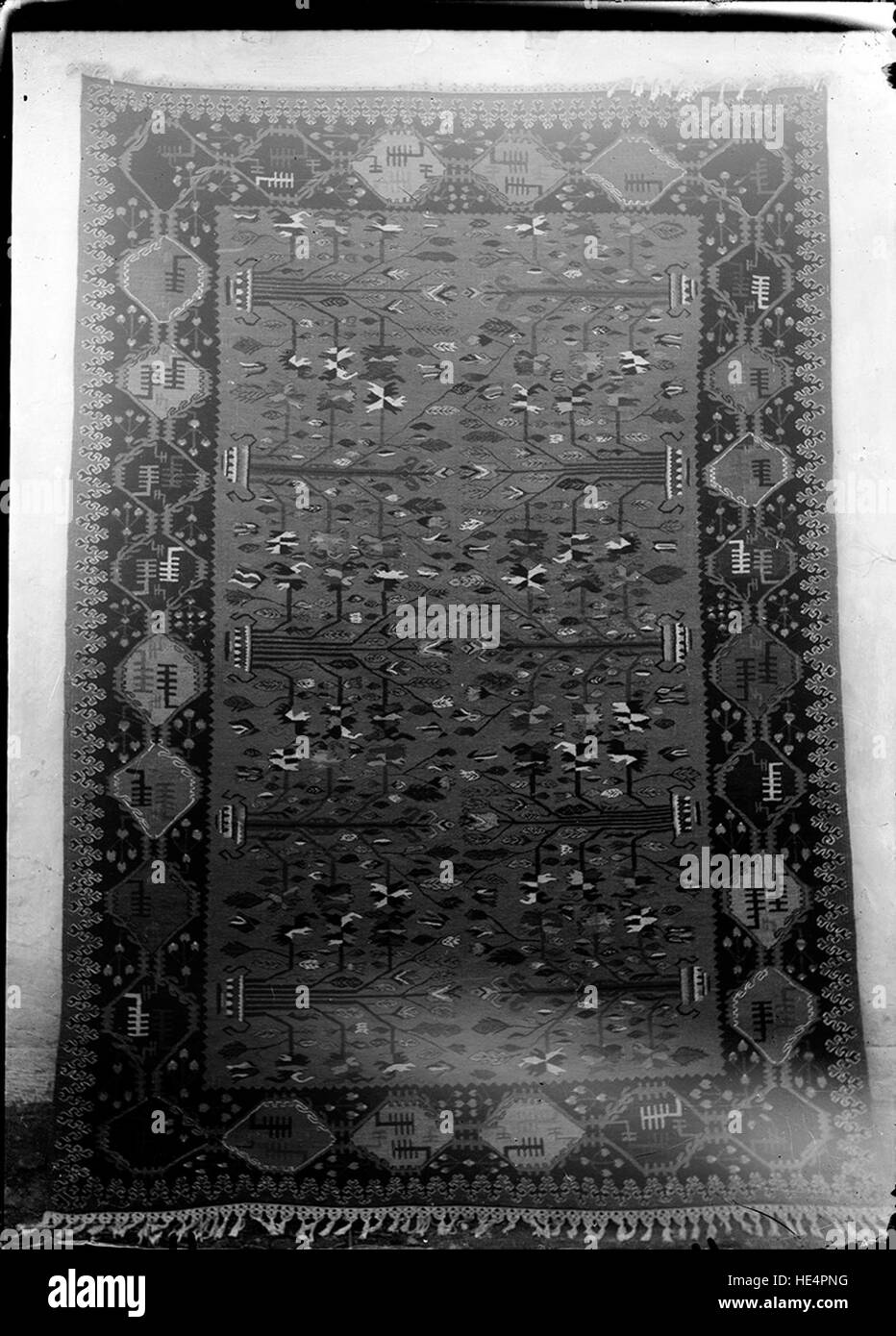 A photograph of a traditional Romanian carpet, captured on a glass ...
