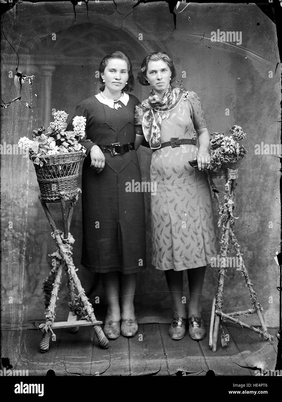 Two women from Romania, captured in a historical photograph, reflecting ...