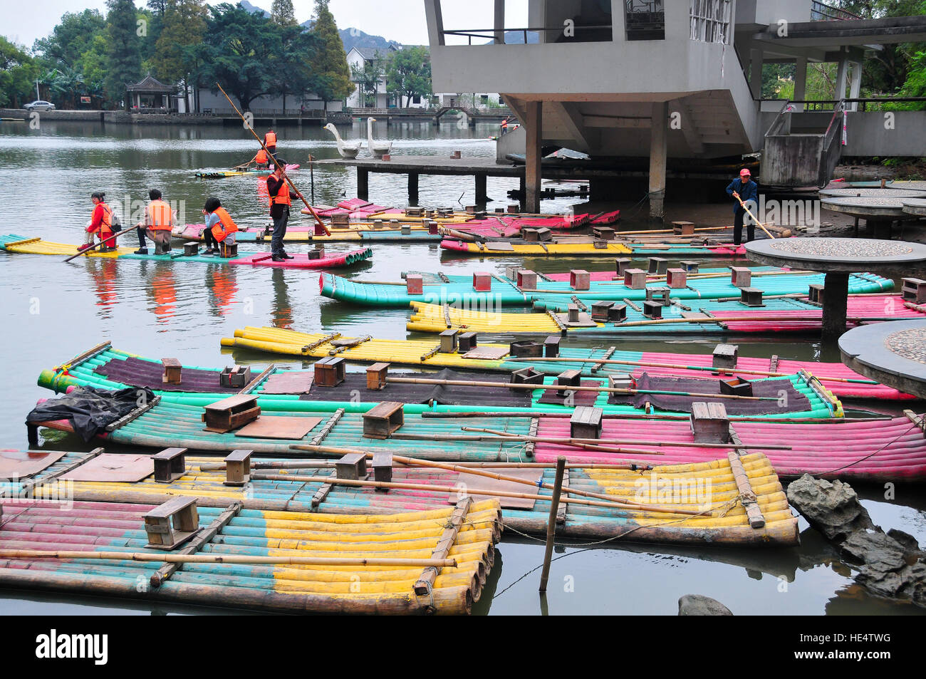Tourists enjoy a bamboo raft ride on a lake at Reed Flute Cave in ...
