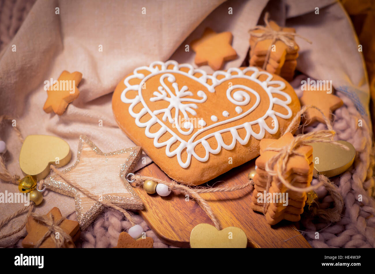 Gingerbread heart-shaped, sugar stars cookies on knitted backgro Stock ...