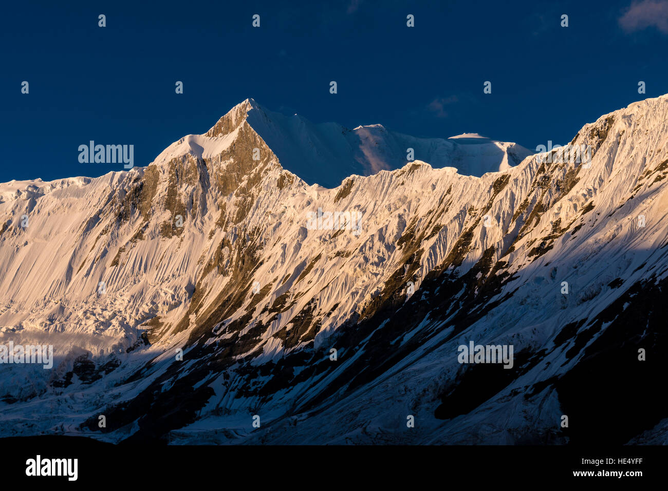 The sunrise is illuminating the summits of Khangsar Kang and Annapurna ...