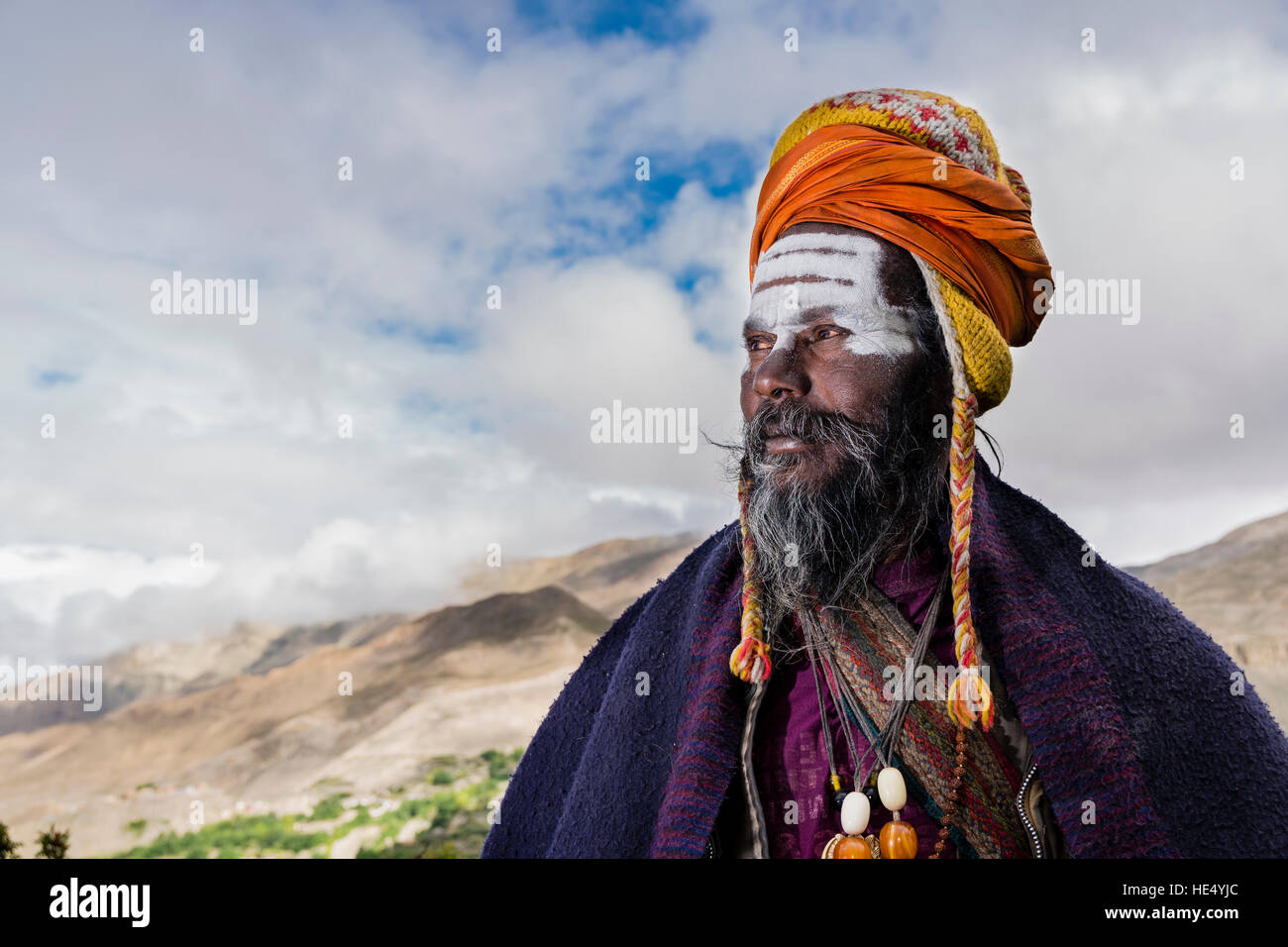 A portrait of a Sadhu, holy man, looking into the himalayan mountains ...