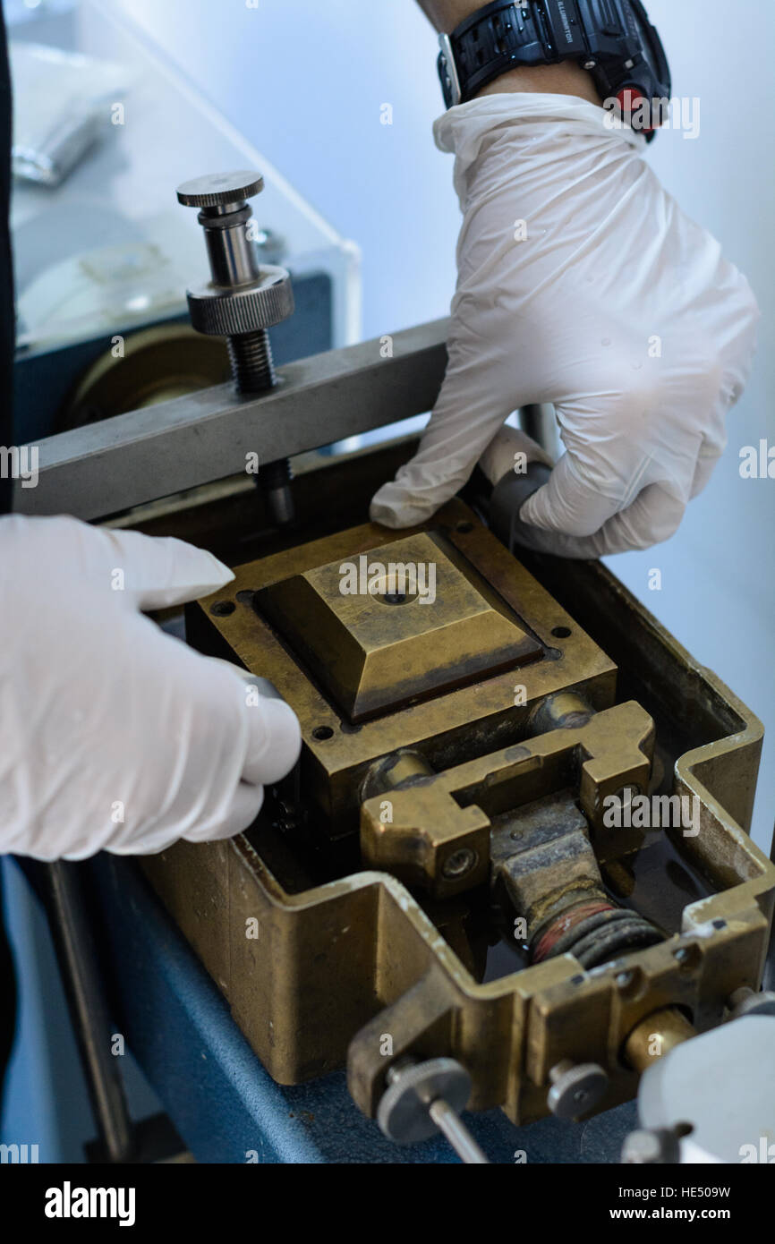 Civil engineer using a direct shear test box for soil parameters ...