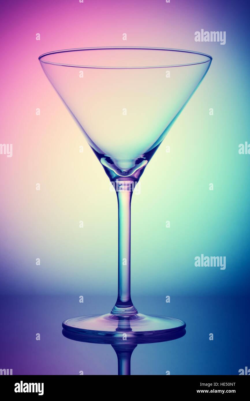 Empty cocktail glass on colorful background Stock Photo - Alamy