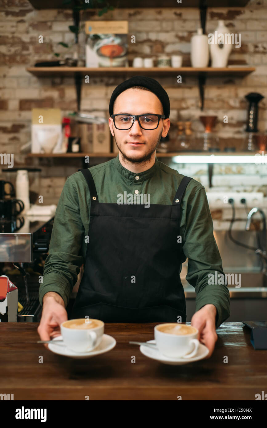 Waiter in black apron hi-res stock photography and images - Alamy