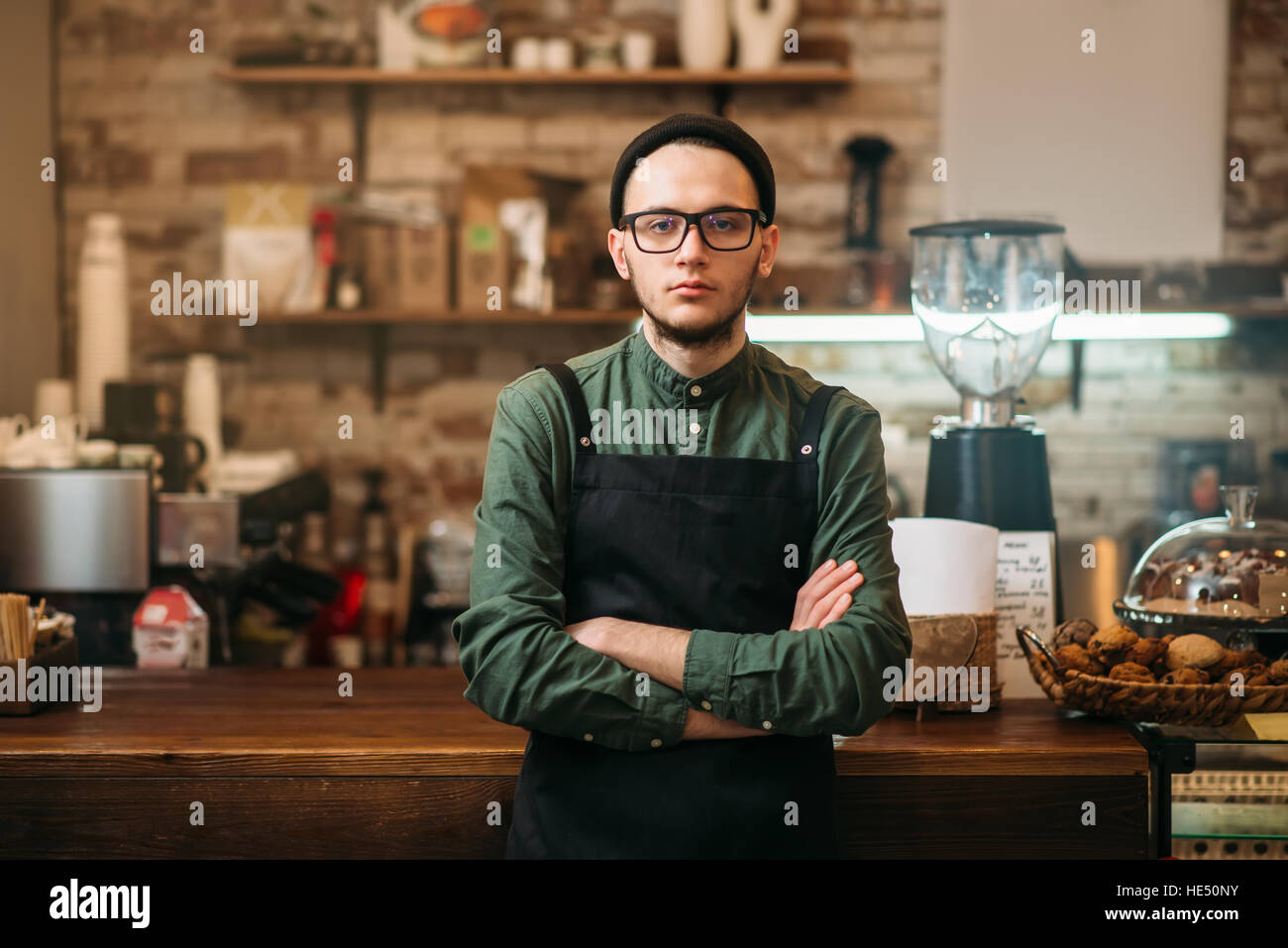 Barman standing against bar counter Stock Photo - Alamy