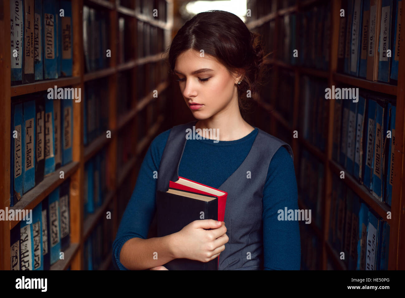 Student girl or woman with books in library Stock Photo - Alamy
