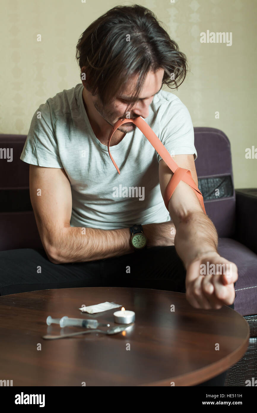 Narcotic addict make injection himself Stock Photo - Alamy