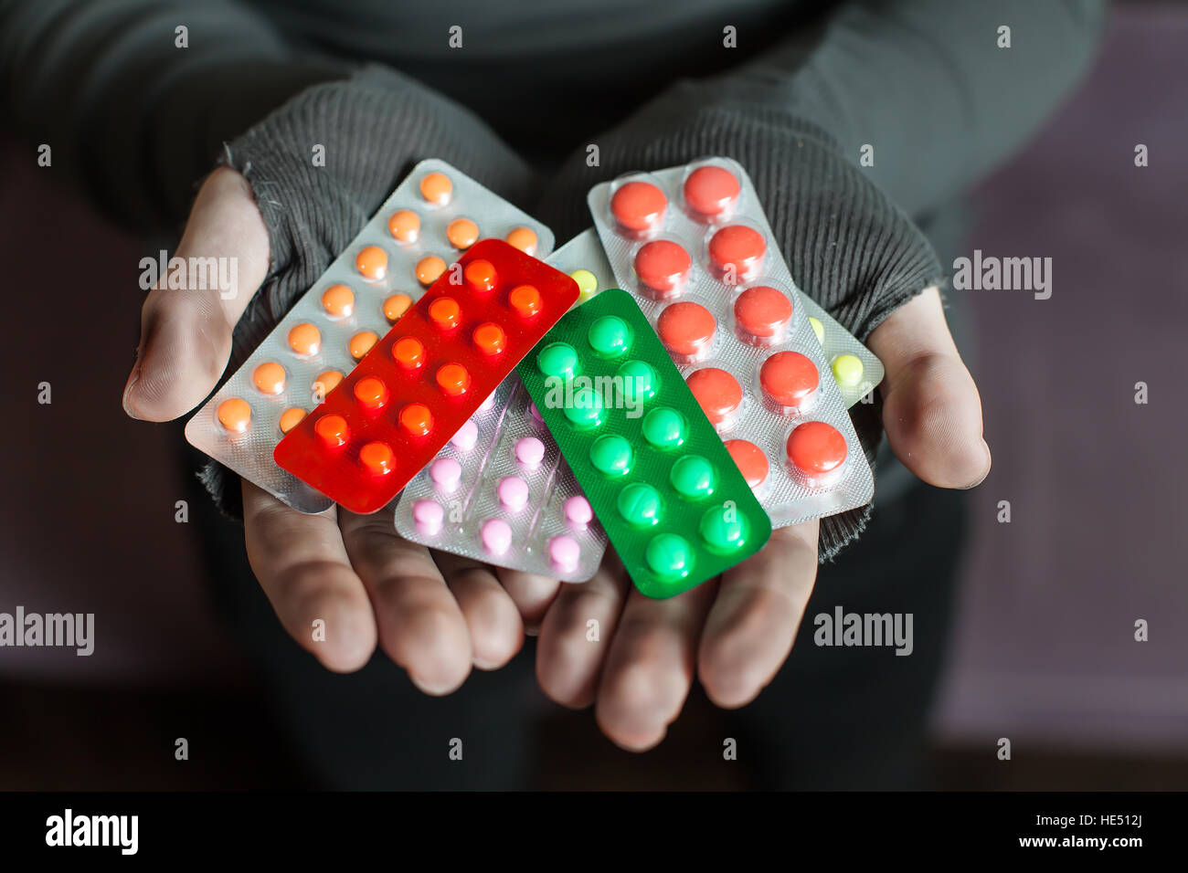 Male hands is holding a lot of different tablets Stock Photo - Alamy