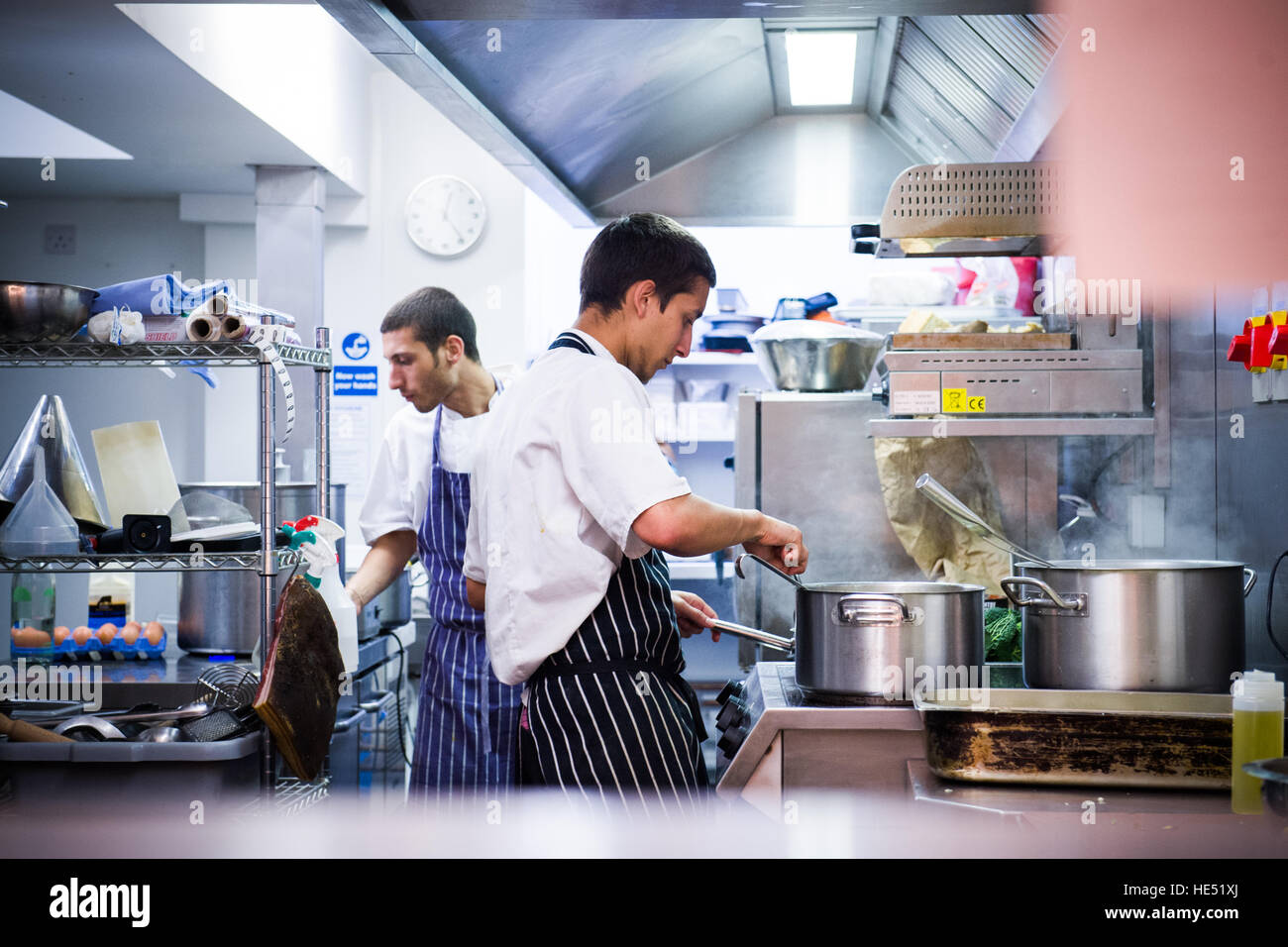 Chefs working in a busy restaurant kitchen Stock Photo - Alamy