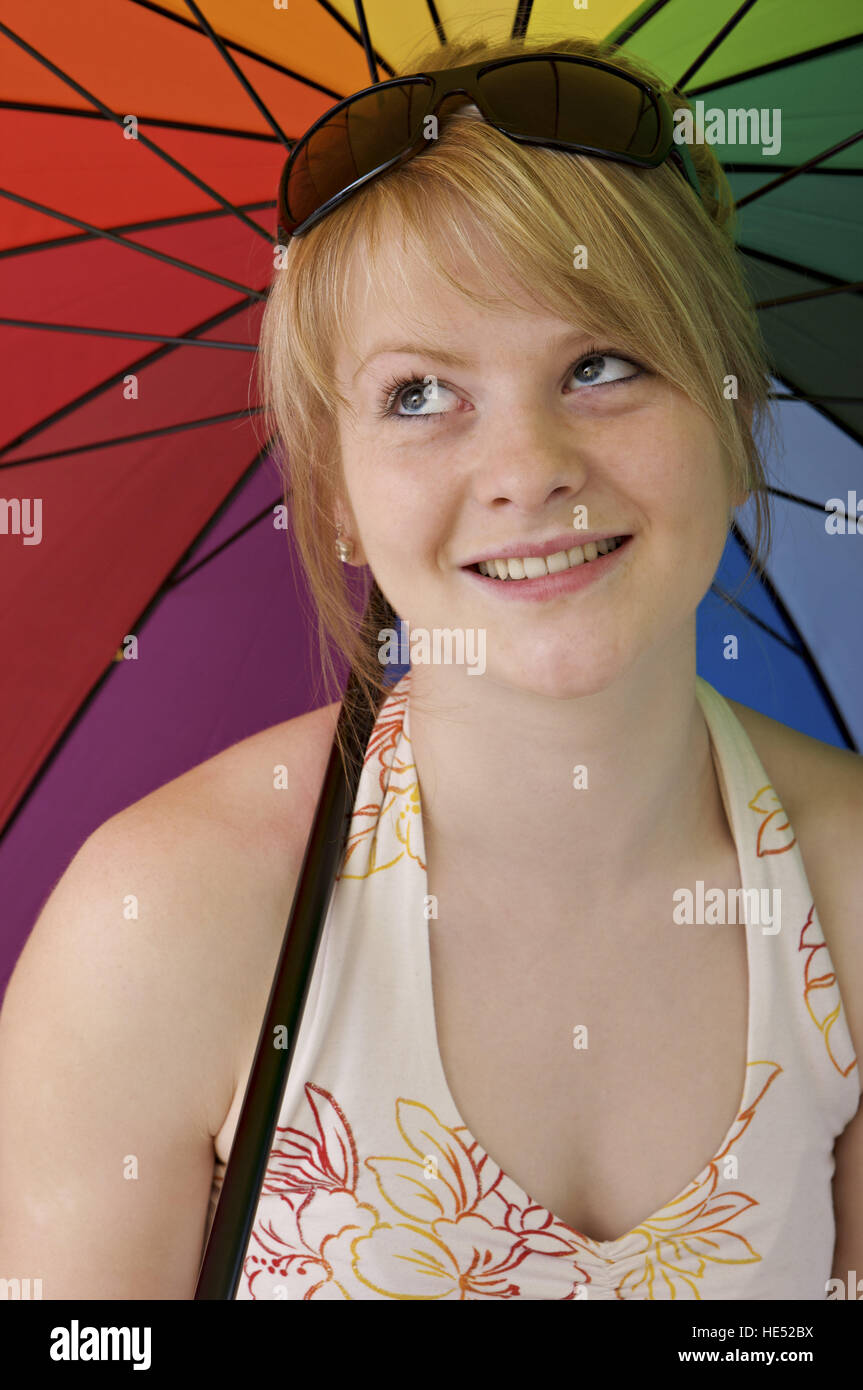 Woman standing underneath a colorful umbrella Stock Photo - Alamy