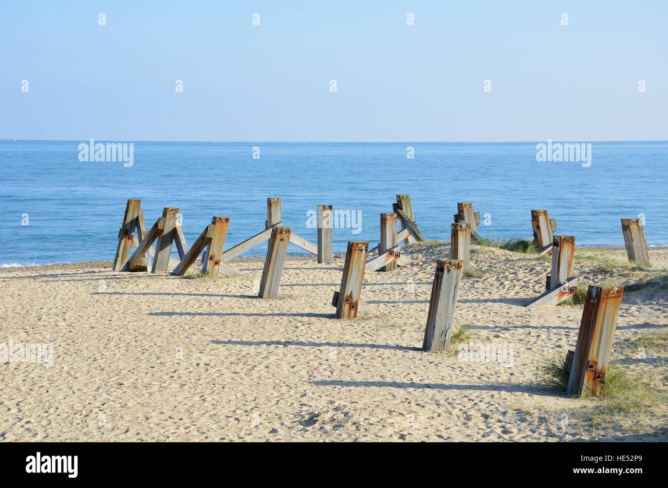 Weathered wooden posts in ground by the sea Stock Photo - Alamy