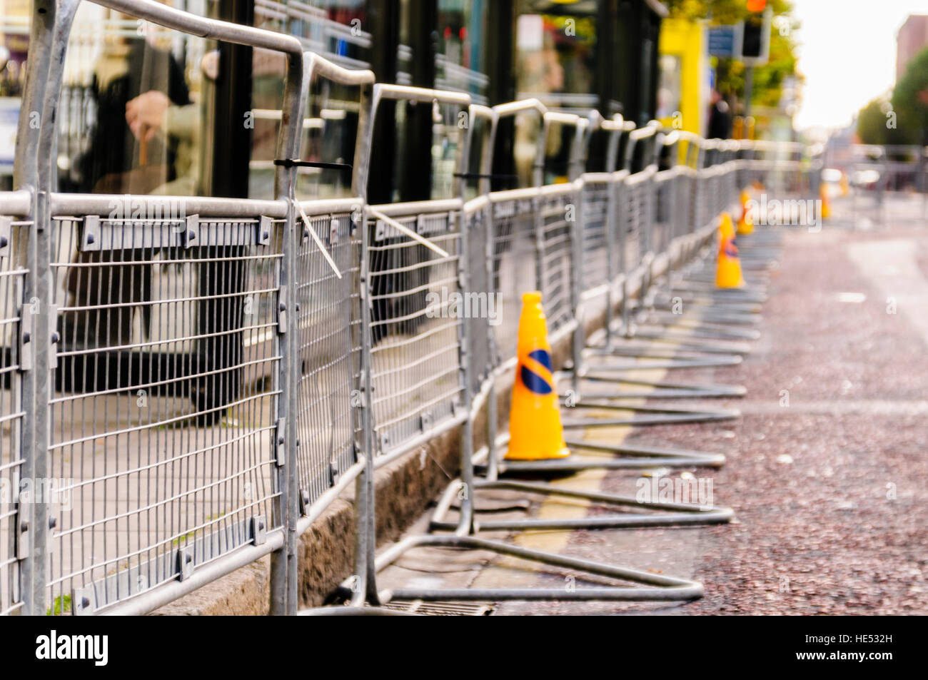 Crowd control barriers line a road to keep people back in advance of an ...