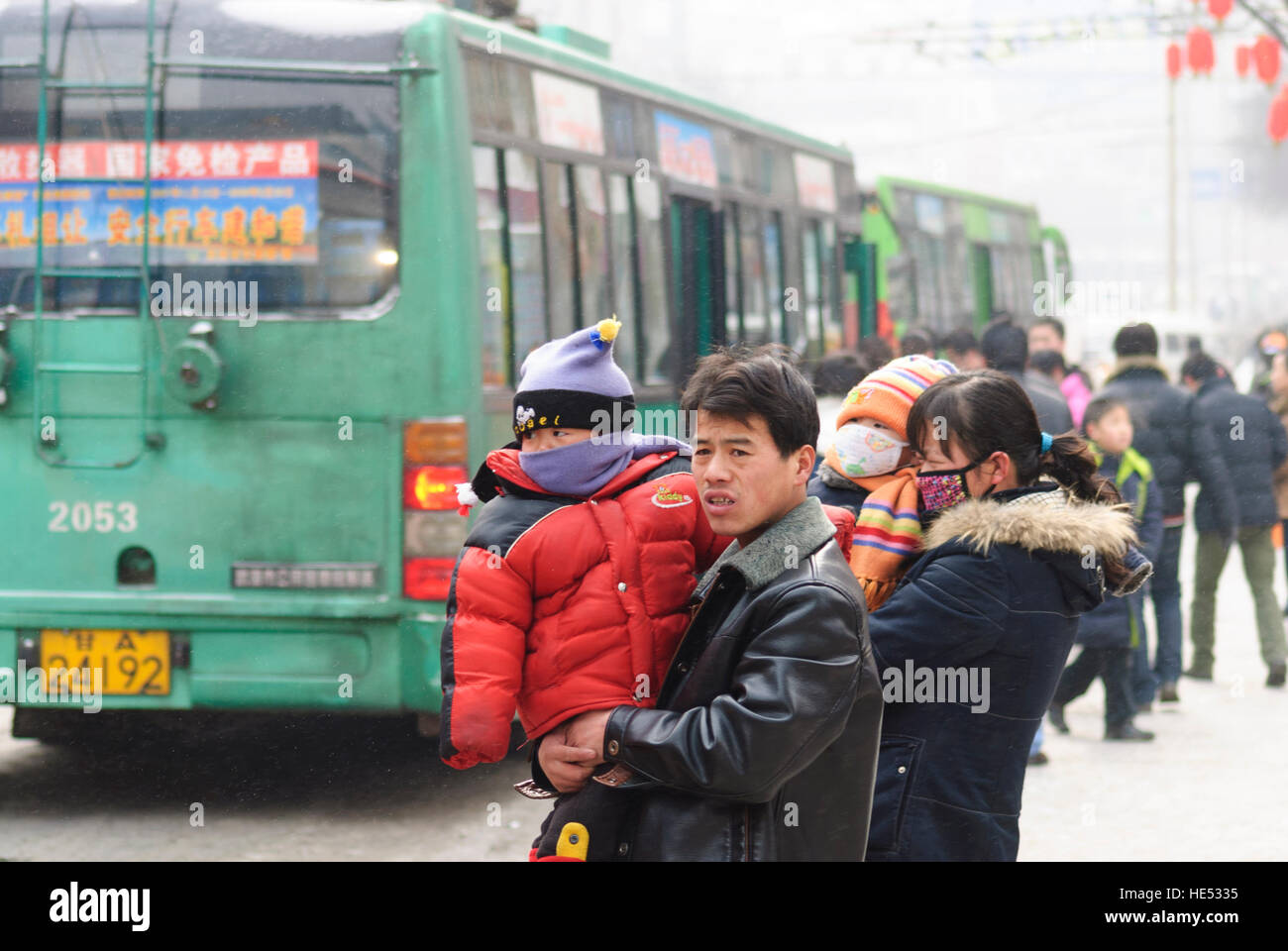 Lanzhou: Man and boy, waiting for the city bus, Gansu, China Stock ...
