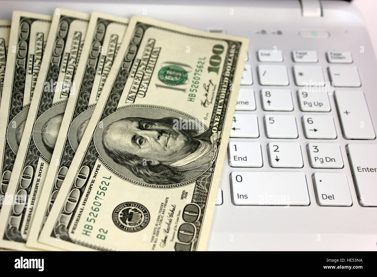 Dollars and computer Stock Photo - Alamy
