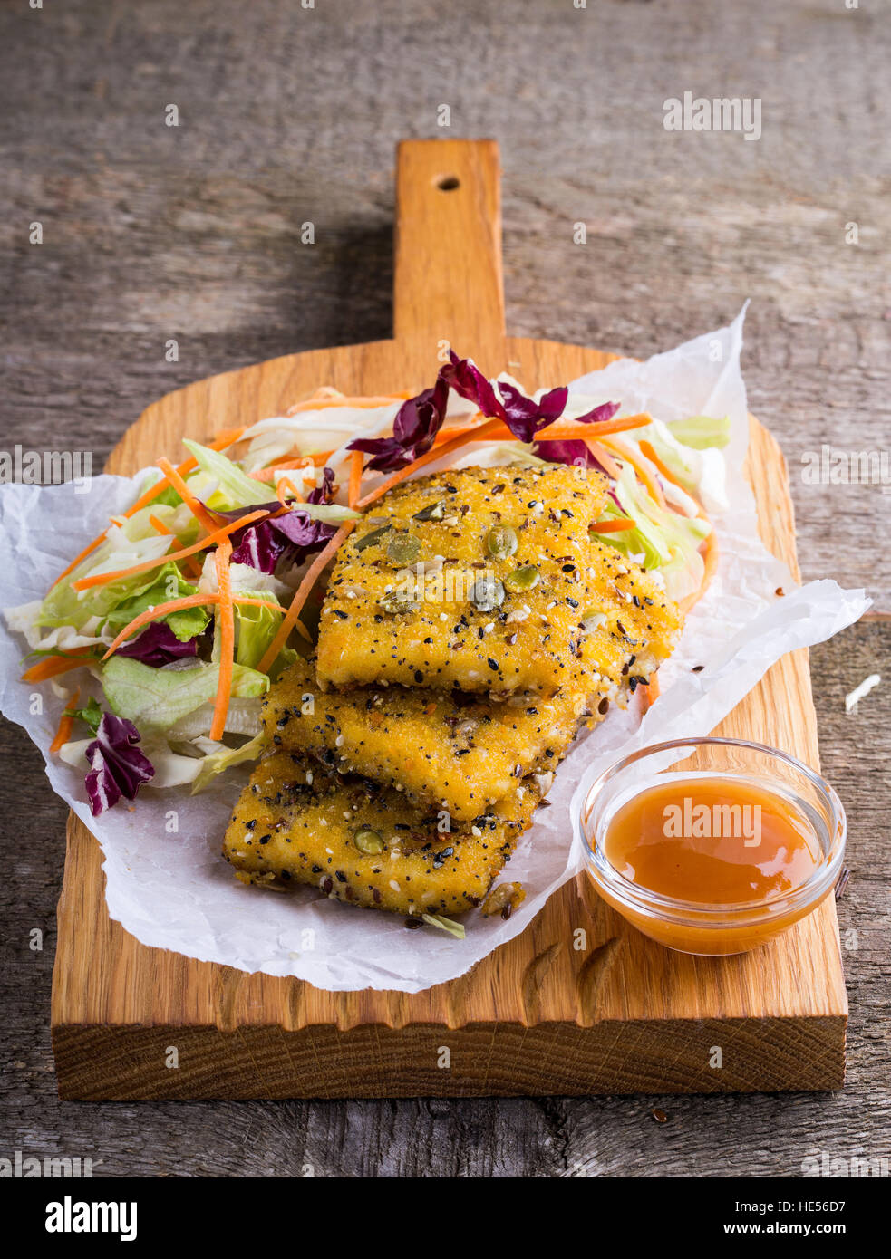 Fish fillet coated with bread crumbs and various seeds Stock Photo - Alamy