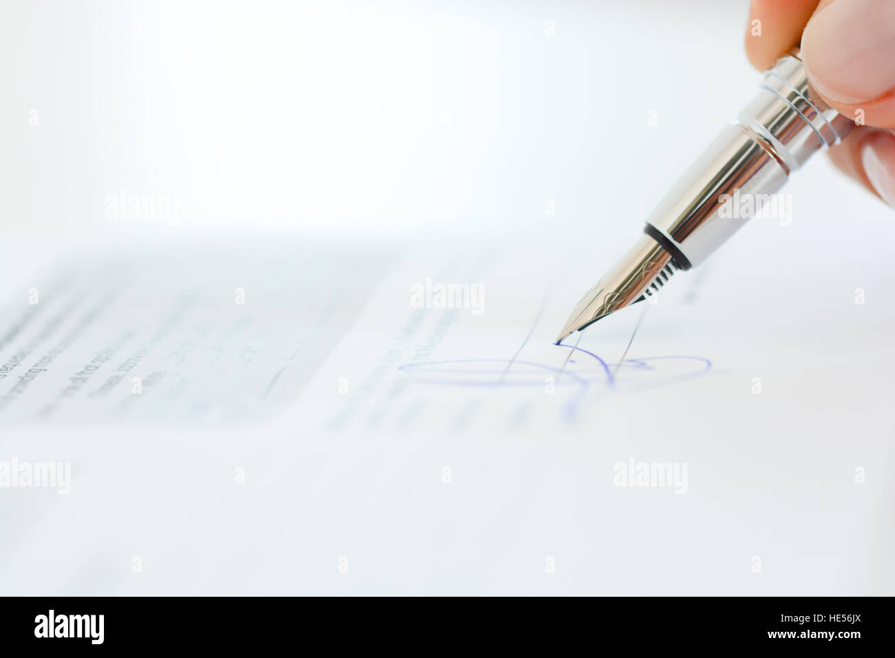 Sign a contract or agreement with a pen Stock Photo - Alamy
