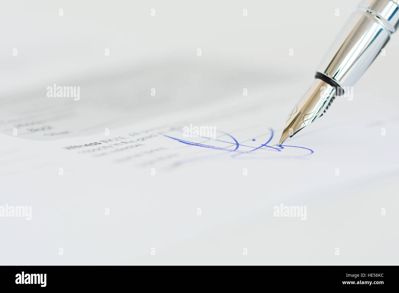 Sign a contract or agreement with a pen Stock Photo - Alamy