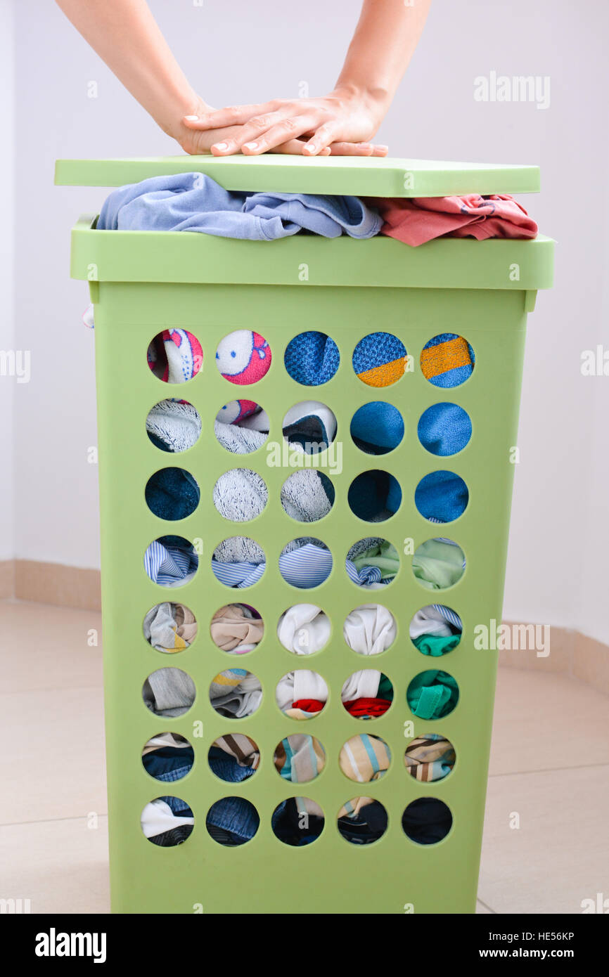 Full laundry basket with dirty clothes Stock Photo - Alamy