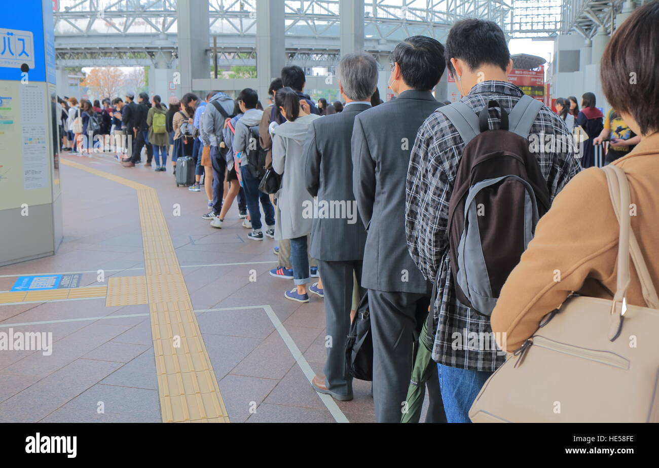 People queue at Kanazawa station bus terminal Stock Photo - Alamy