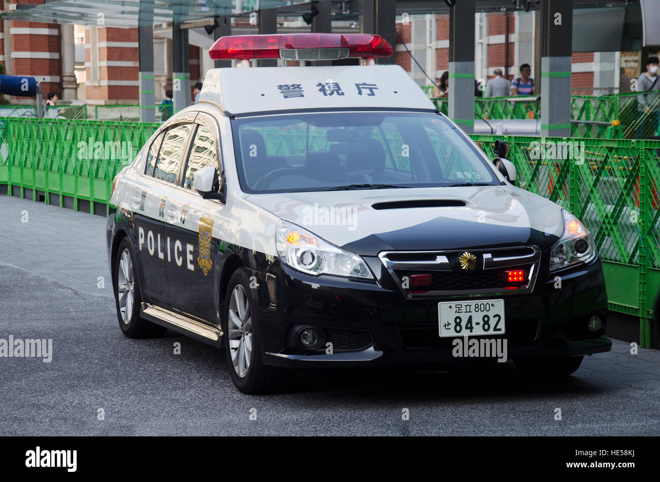 Japanese policemen people driving cop car on the road for check over ...
