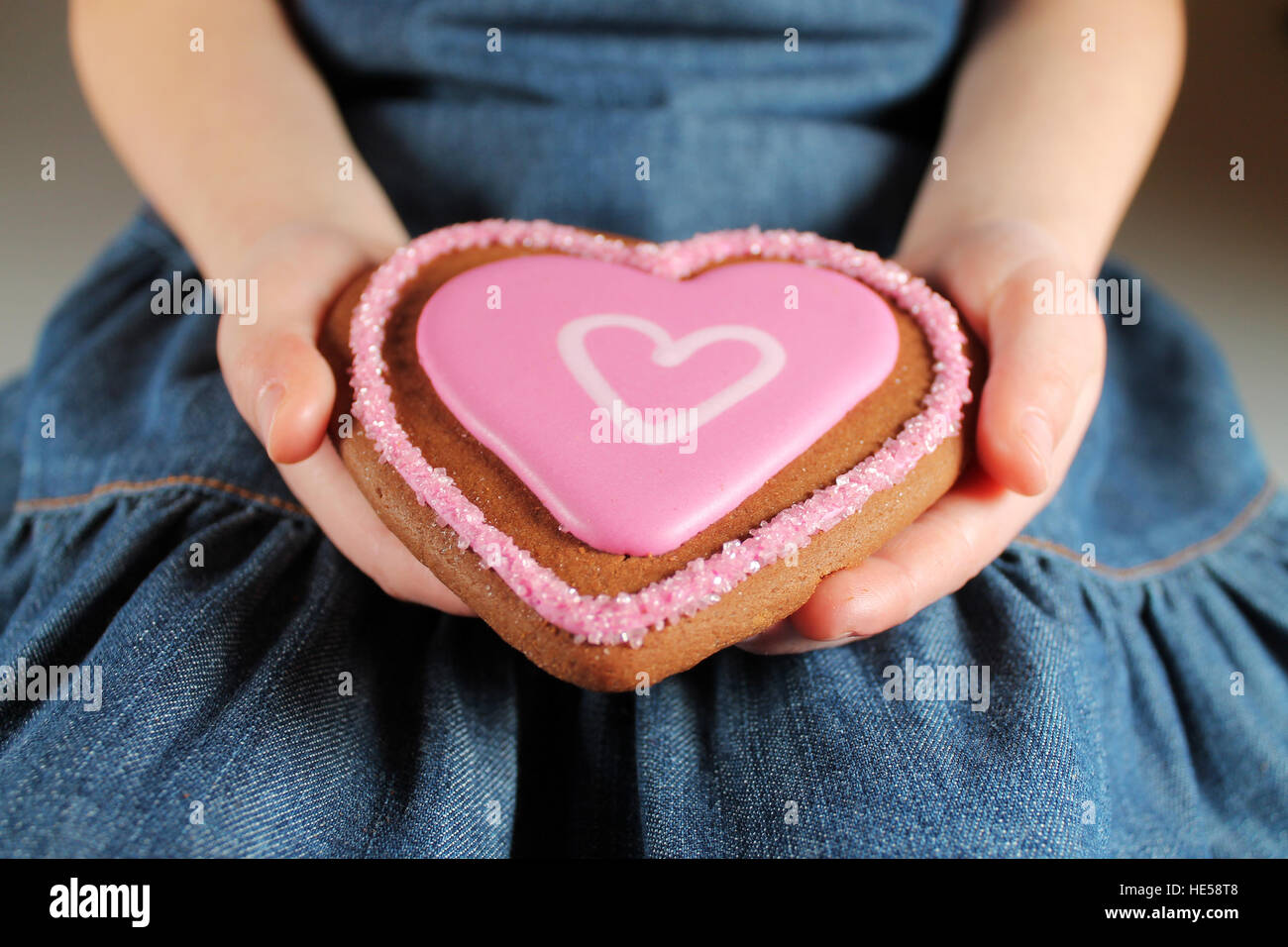 Heart shaped gingerbread in children hands Stock Photo - Alamy