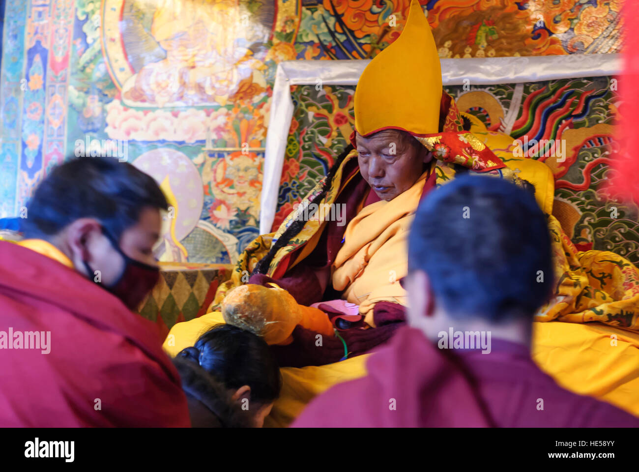 Lhasa: Monastery Sera; Pilgrims stand to receive the blessing of a lama ...