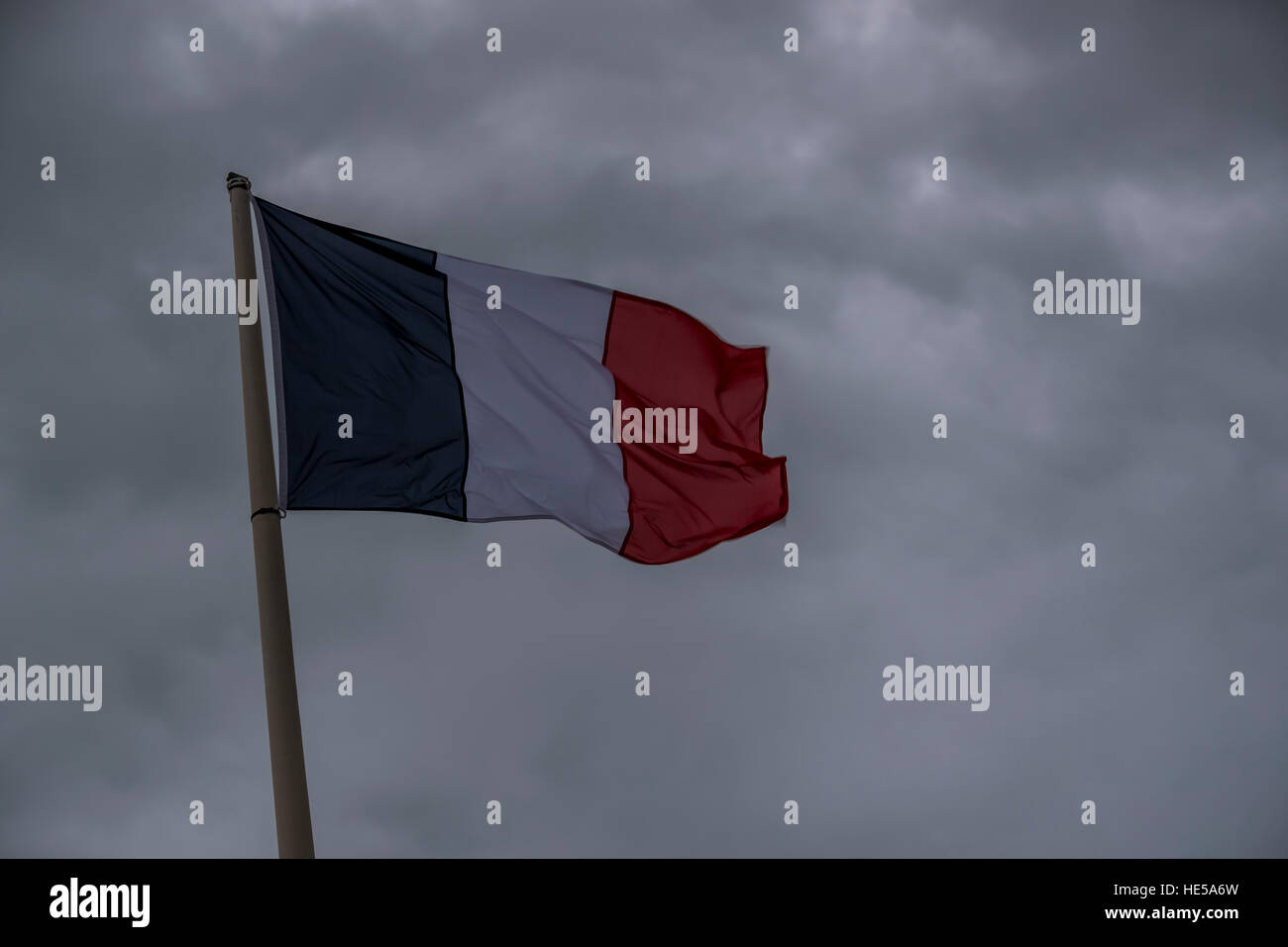 French flag flying in a strong wind on the coast at Dunkirk, France ...